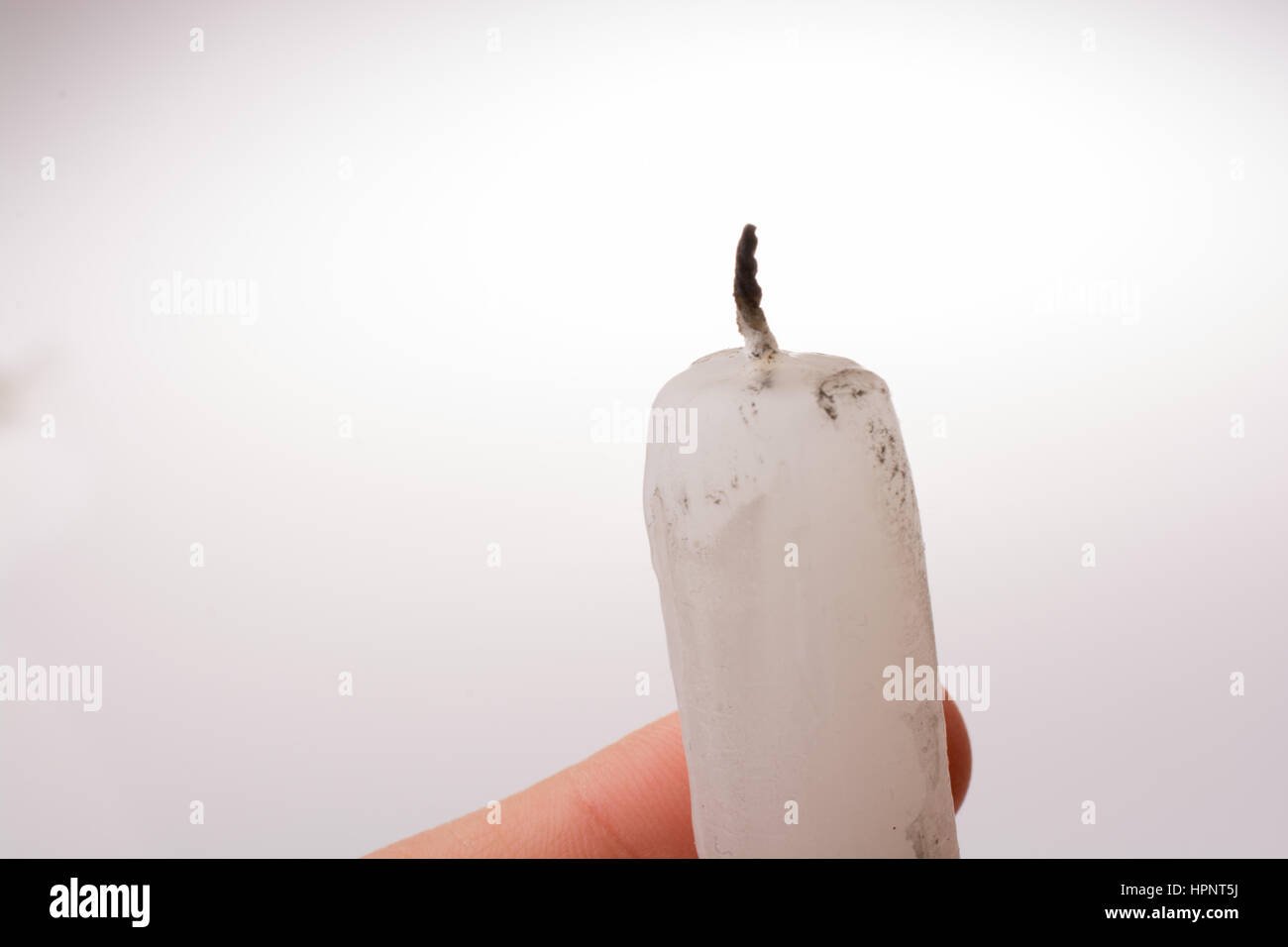 White candle stick in hand on a white background Stock Photo - Alamy