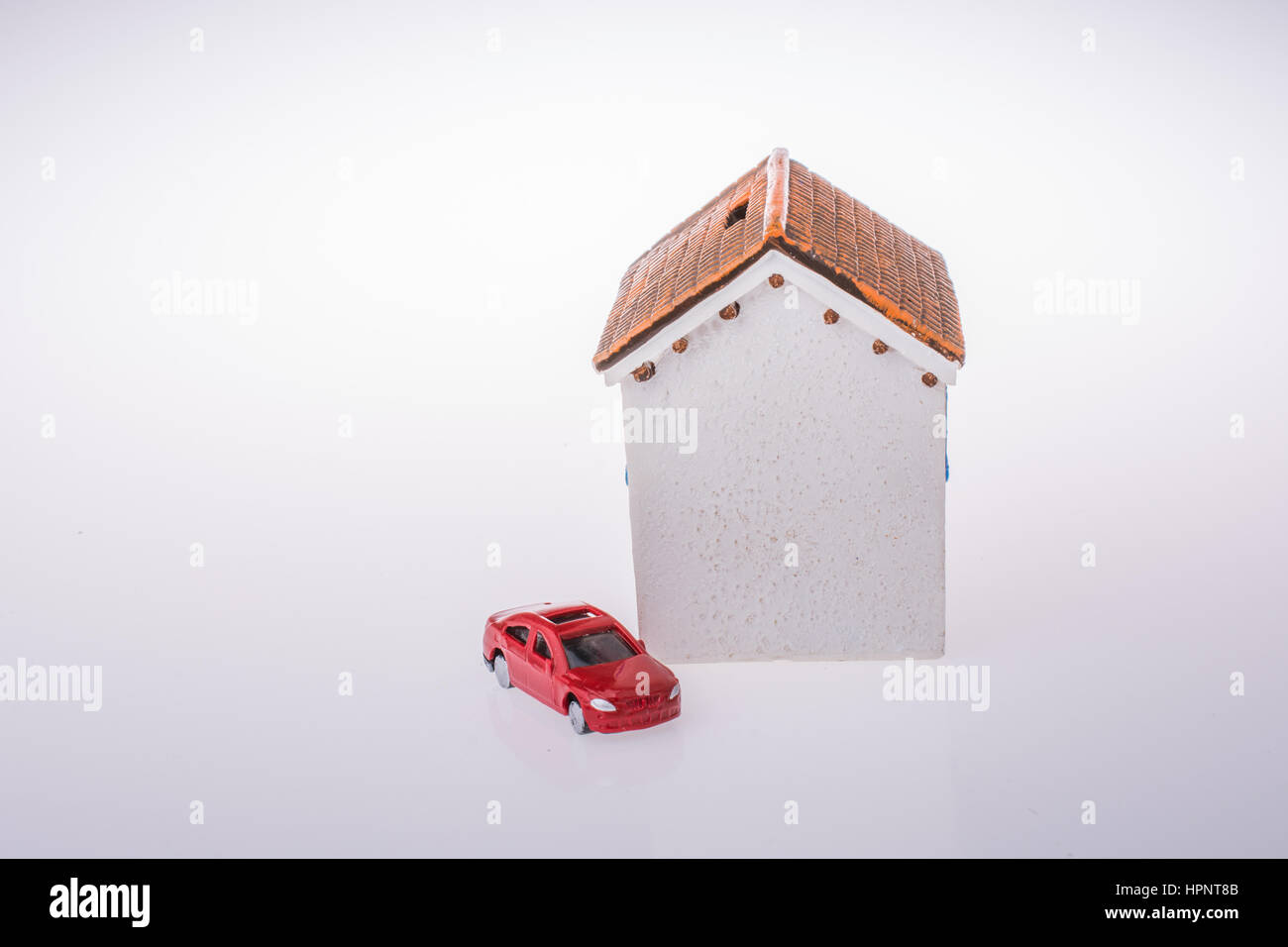 Little model house and a car on a white background Stock Photo - Alamy