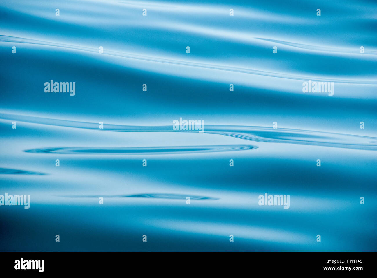 Ripples on the surface of a bright blue ocean in South Africa Stock ...