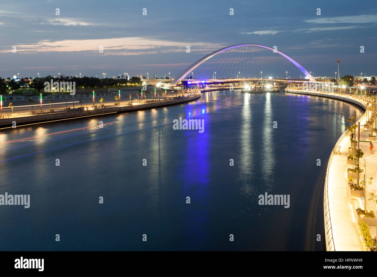 Dubai Water Canal and Arch Bridge illuminated at night. United Arab ...