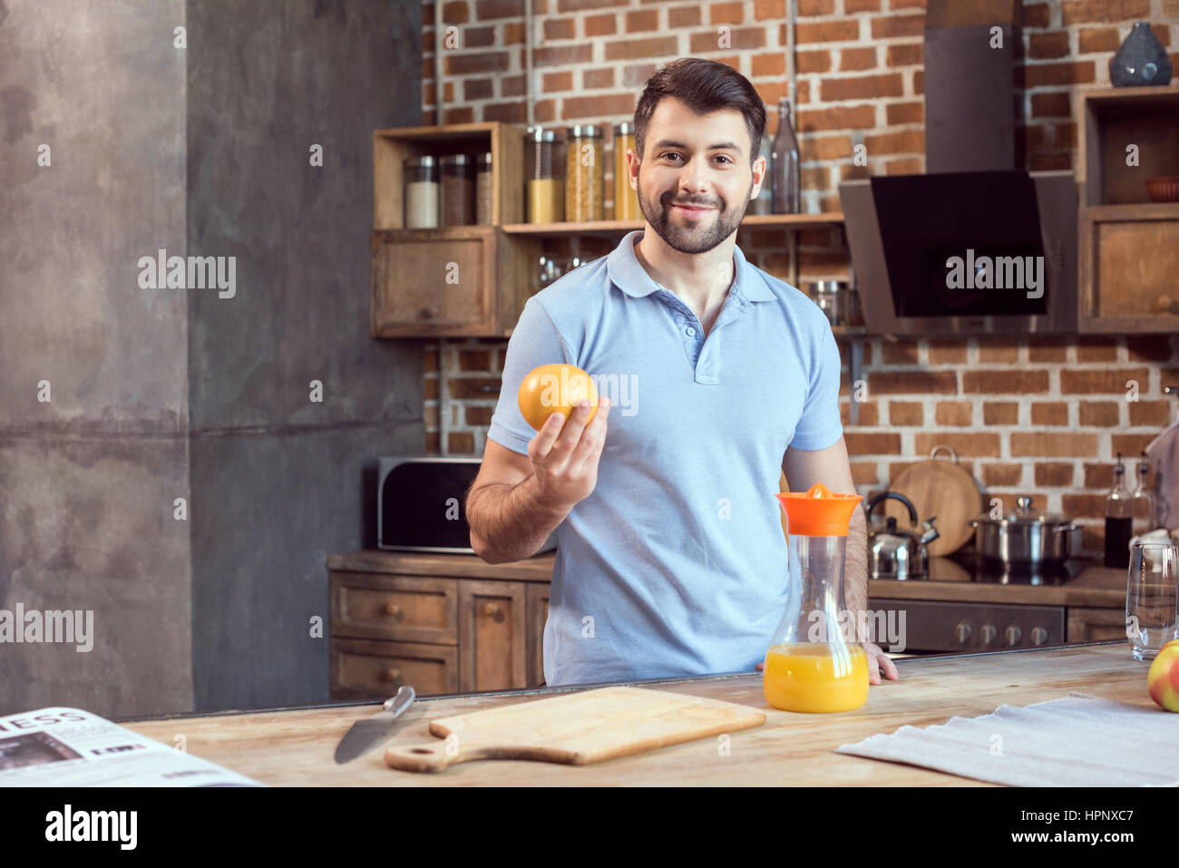 Man squeezing orange juice hi-res stock photography and images - Alamy