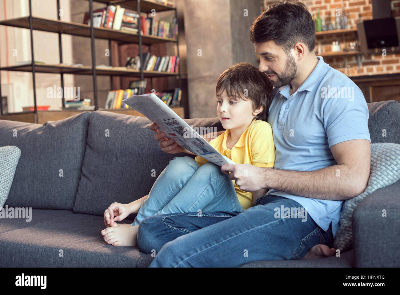 Child reading adult newspaper hi-res stock photography and images - Alamy