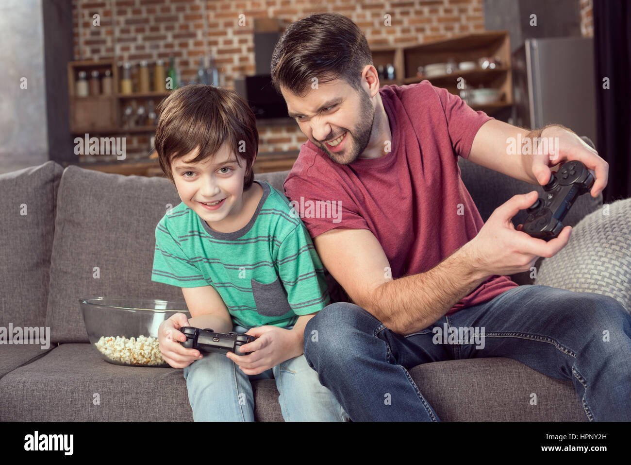 father and son playing video game at home Stock Photo - Alamy