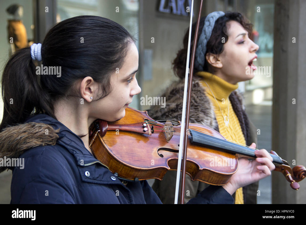 Belgrade, Serbia - Two teenage girls, street musicians, playing violin ...