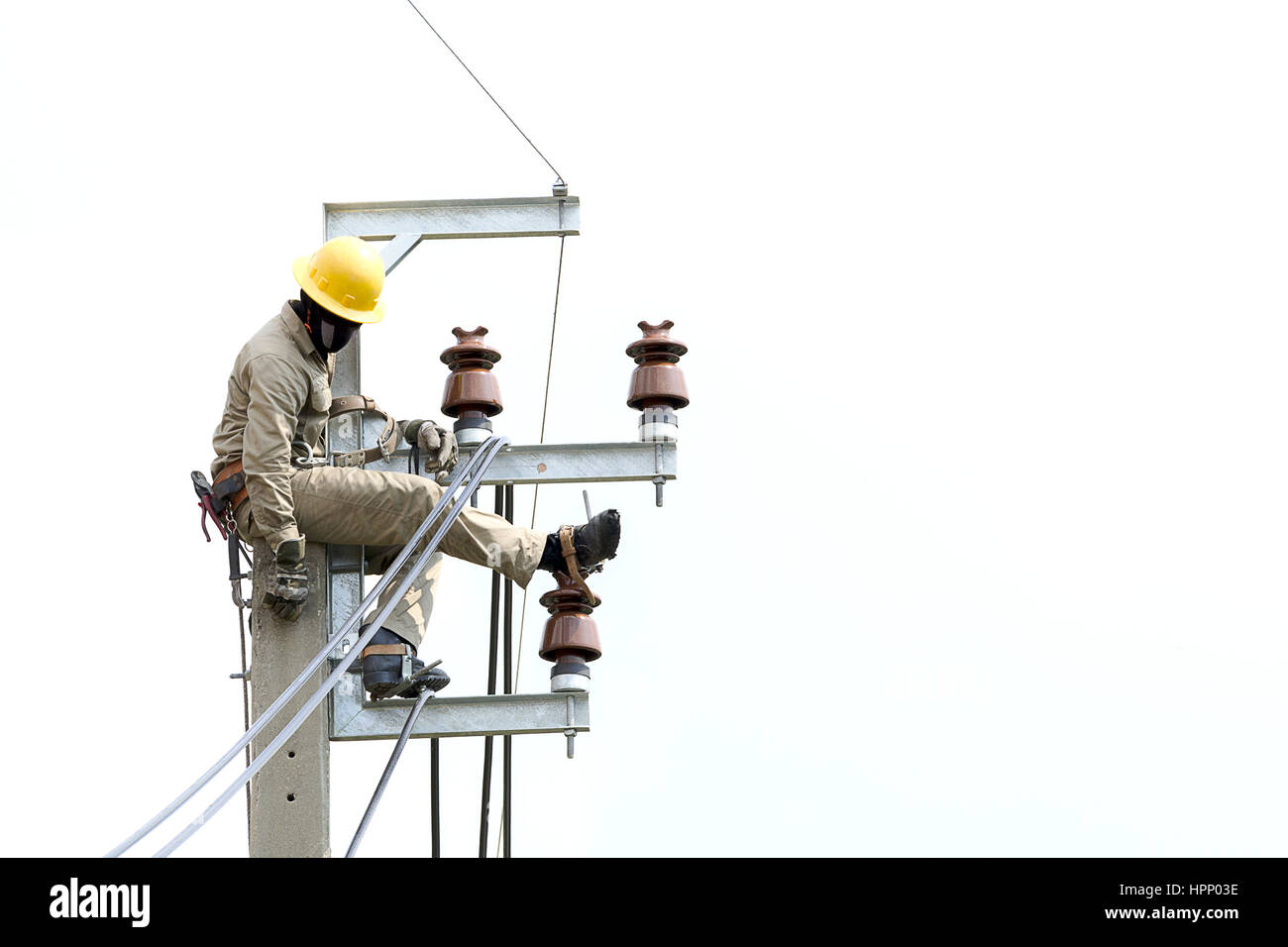 Lineman working on electric line Cut Out Stock Images & Pictures - Alamy