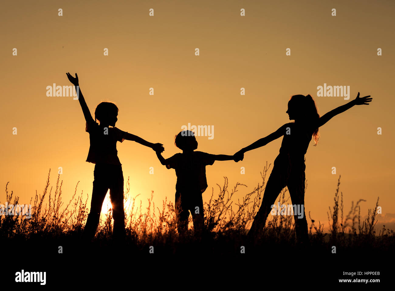 Happy children playing in the park at the sunset time Stock Photo - Alamy