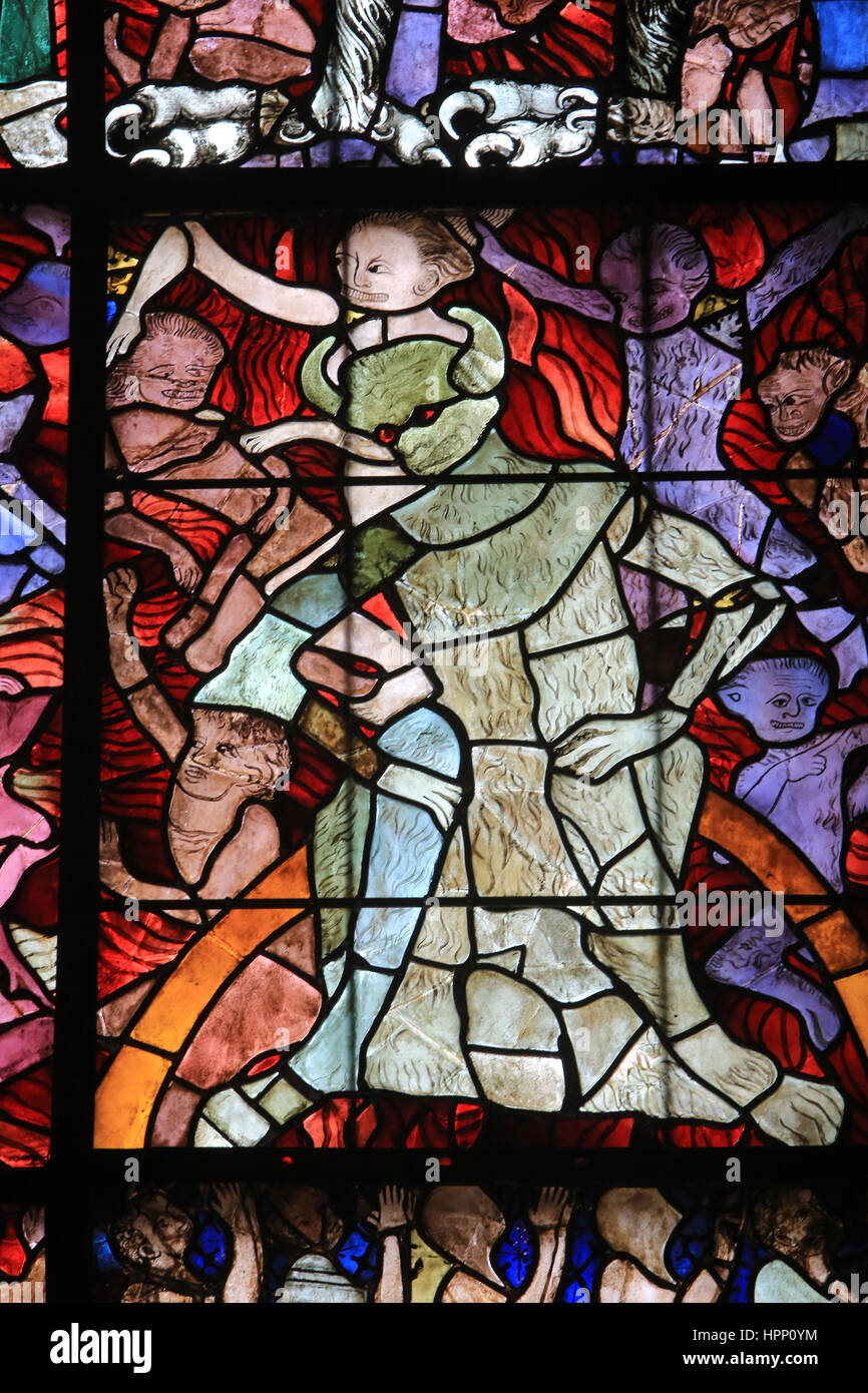 Stained glass representing the devil chained, detail of the canopy of ...