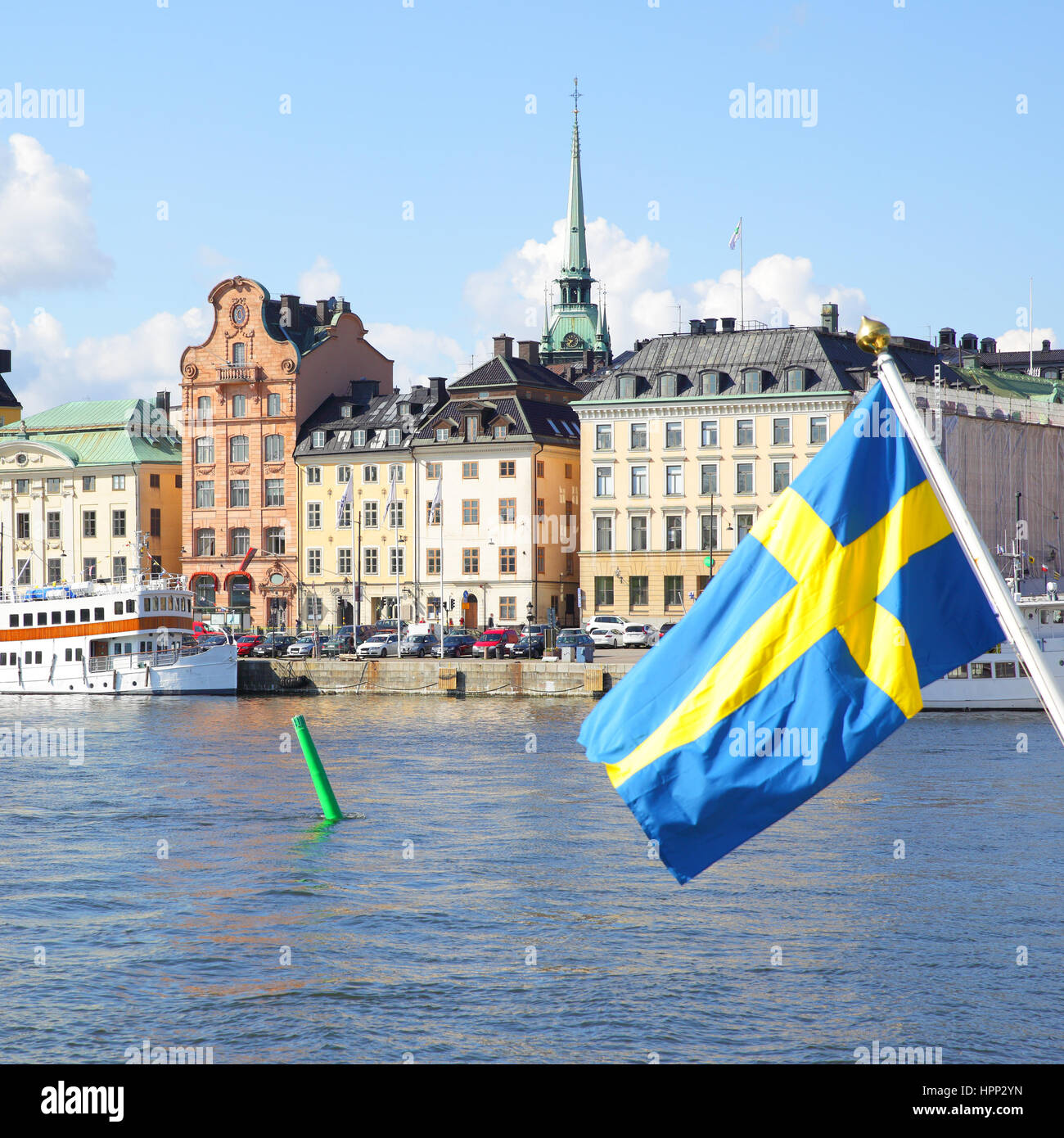 Waterfront in Stockholm and swedish flag. Focus on the buildings Stock ...