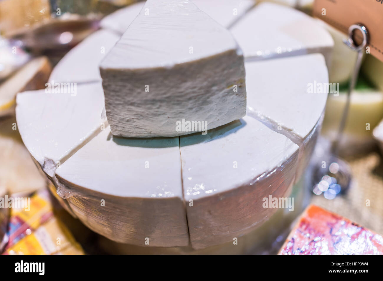 Many packages of brie wrapped in plastic on display Stock Photo - Alamy