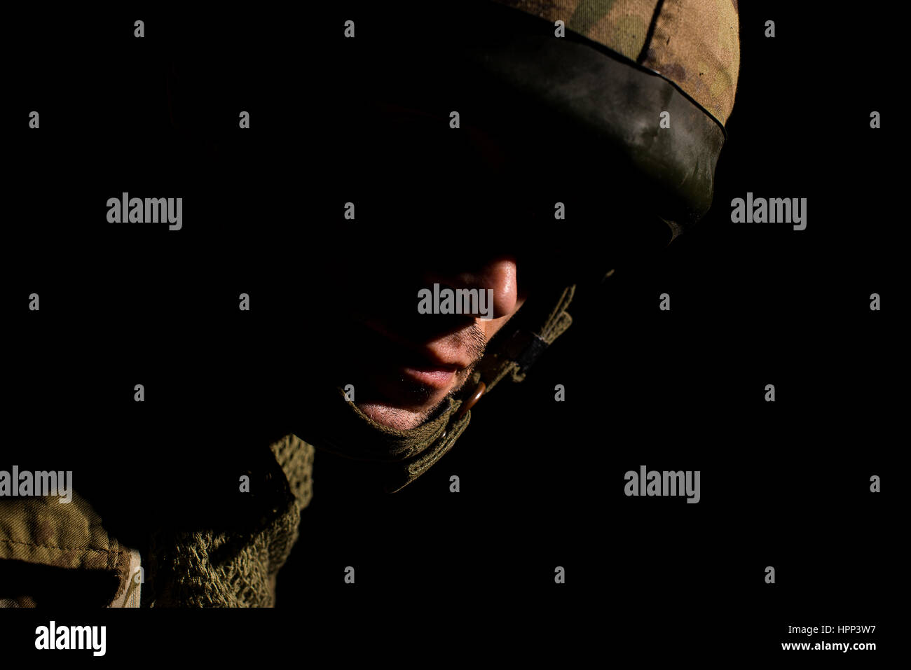 British soldier with face in deep shadow suffering with PTSD Stock ...