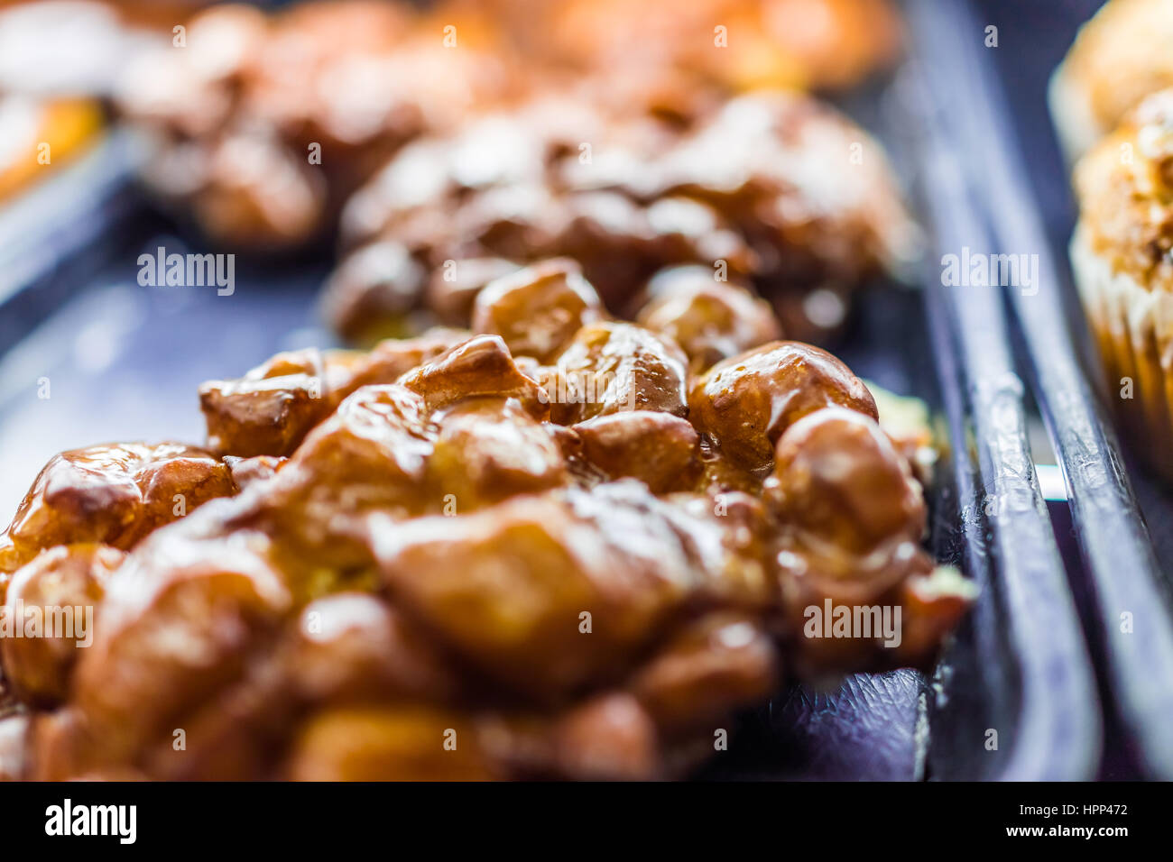 Closeup of golden apple fritter on display Stock Photo - Alamy