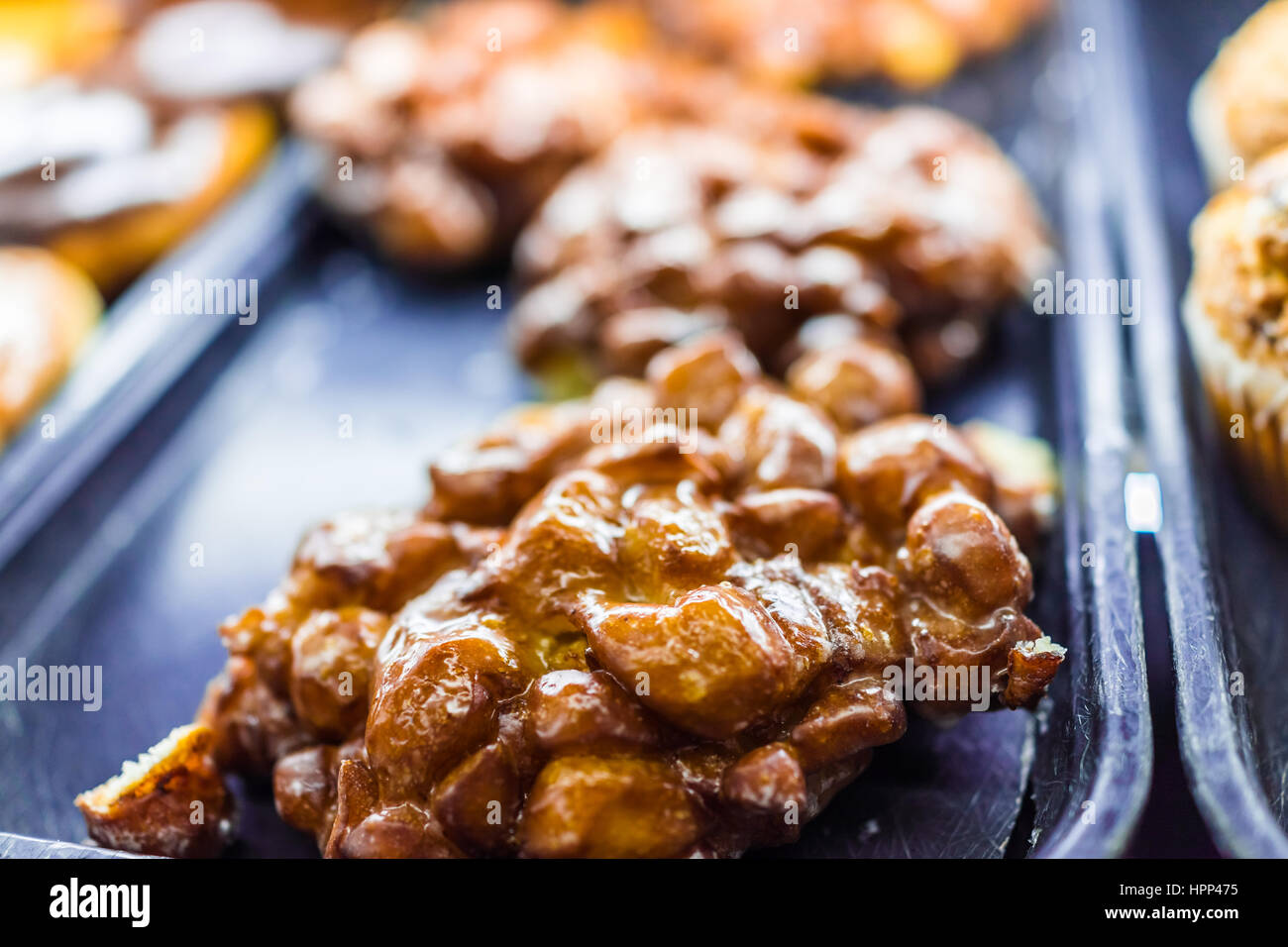Closeup of golden apple fritter on display Stock Photo - Alamy