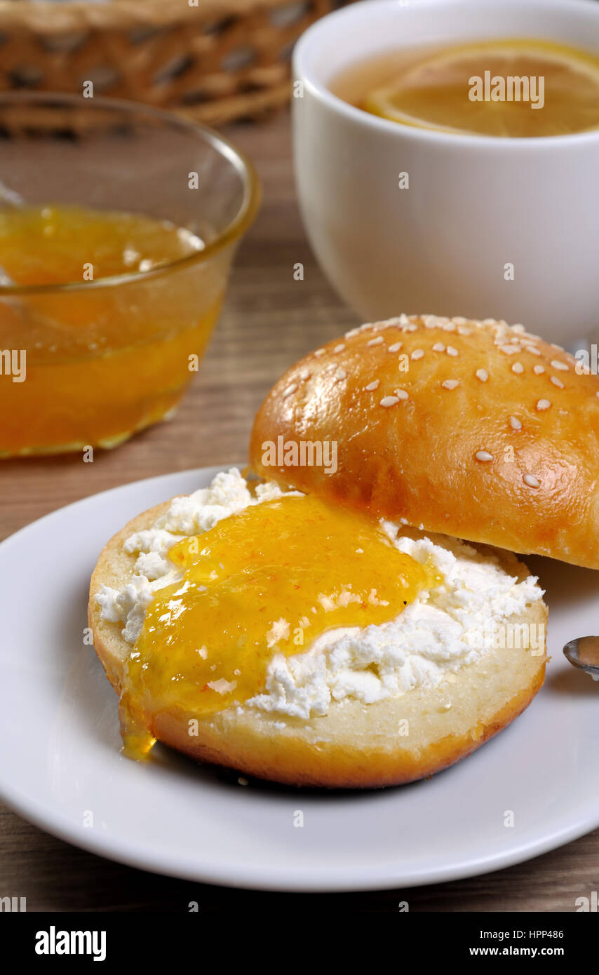 Cut bun with cottage cheese and orange jam Stock Photo - Alamy