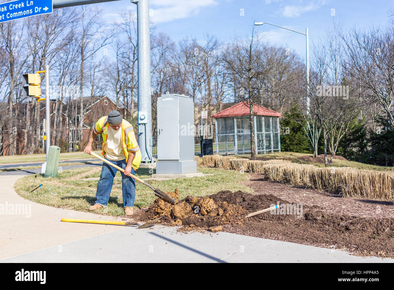 Fairfax, USA - February 18, 2017: Worker digging soil in ground for ...