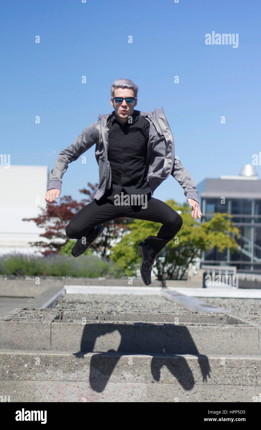 Young man flying levitation jumping hi-res stock photography and images ...