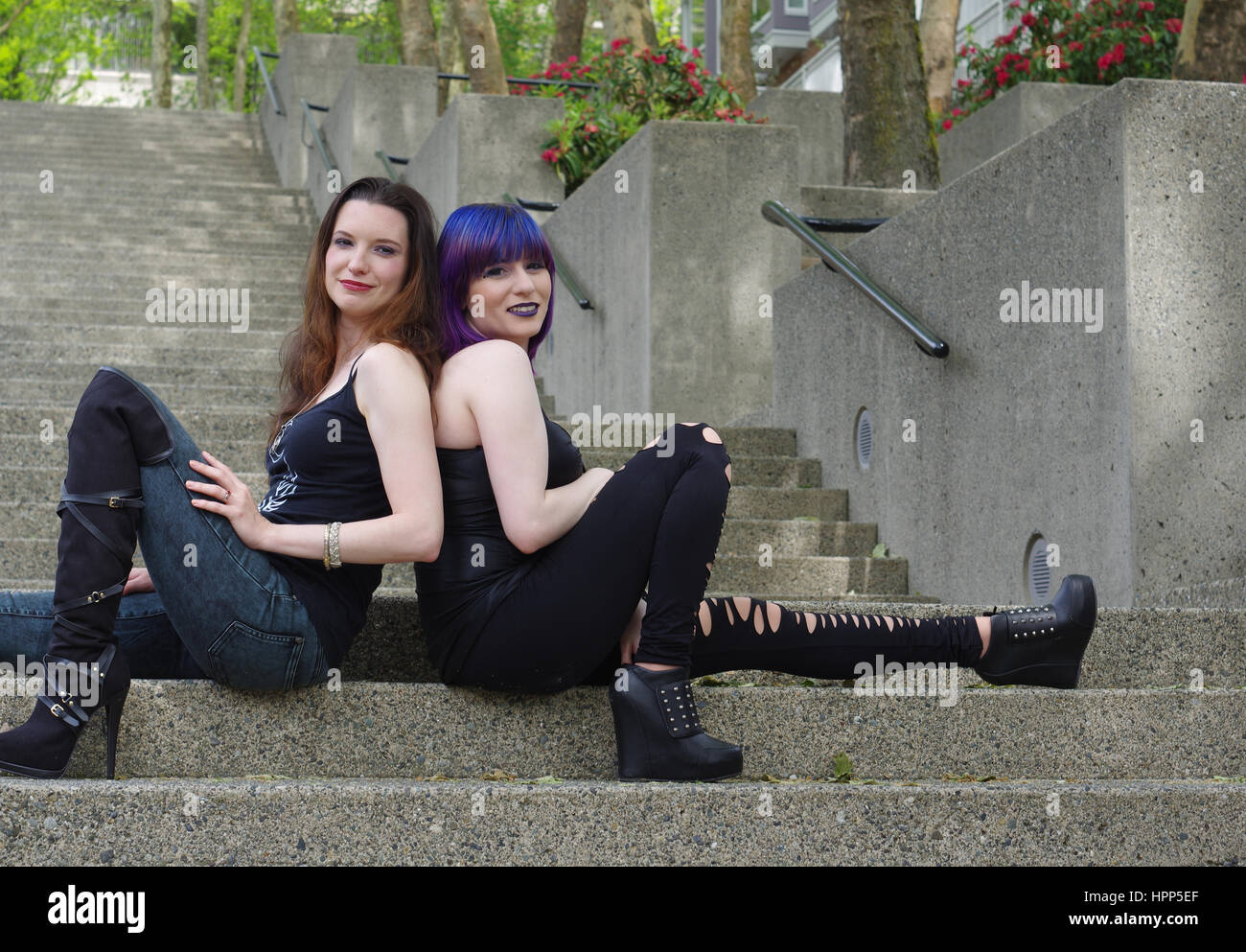Two women sitting on stairs hi-res stock photography and images - Alamy