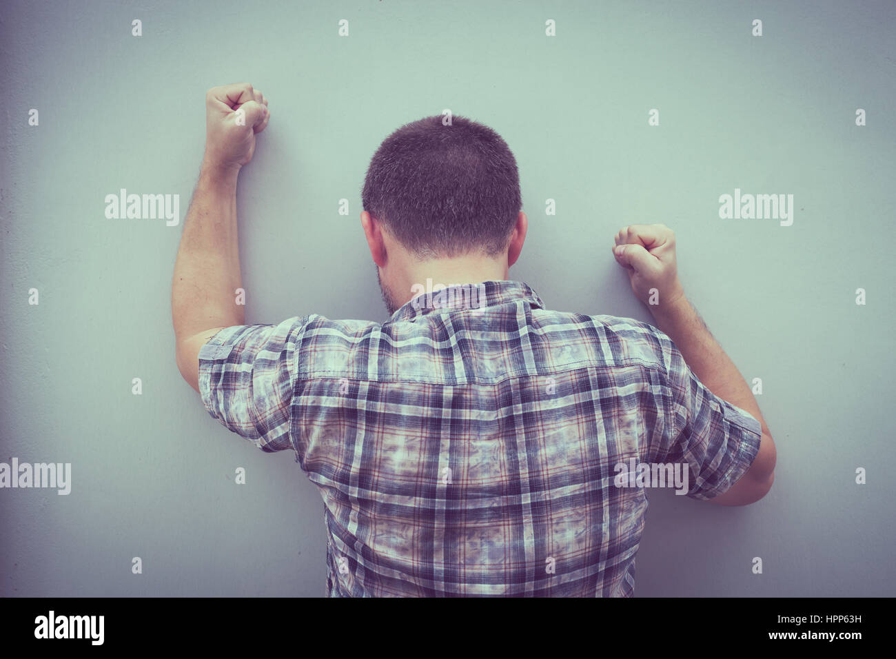 portrait one sad man standing near a wall at the day Stock Photo - Alamy