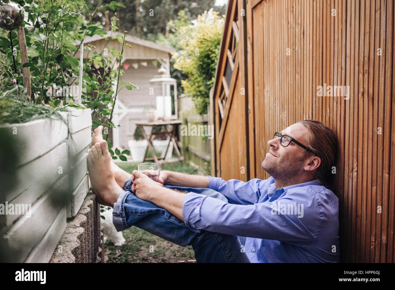 Man relaxing in garden Stock Photo - Alamy