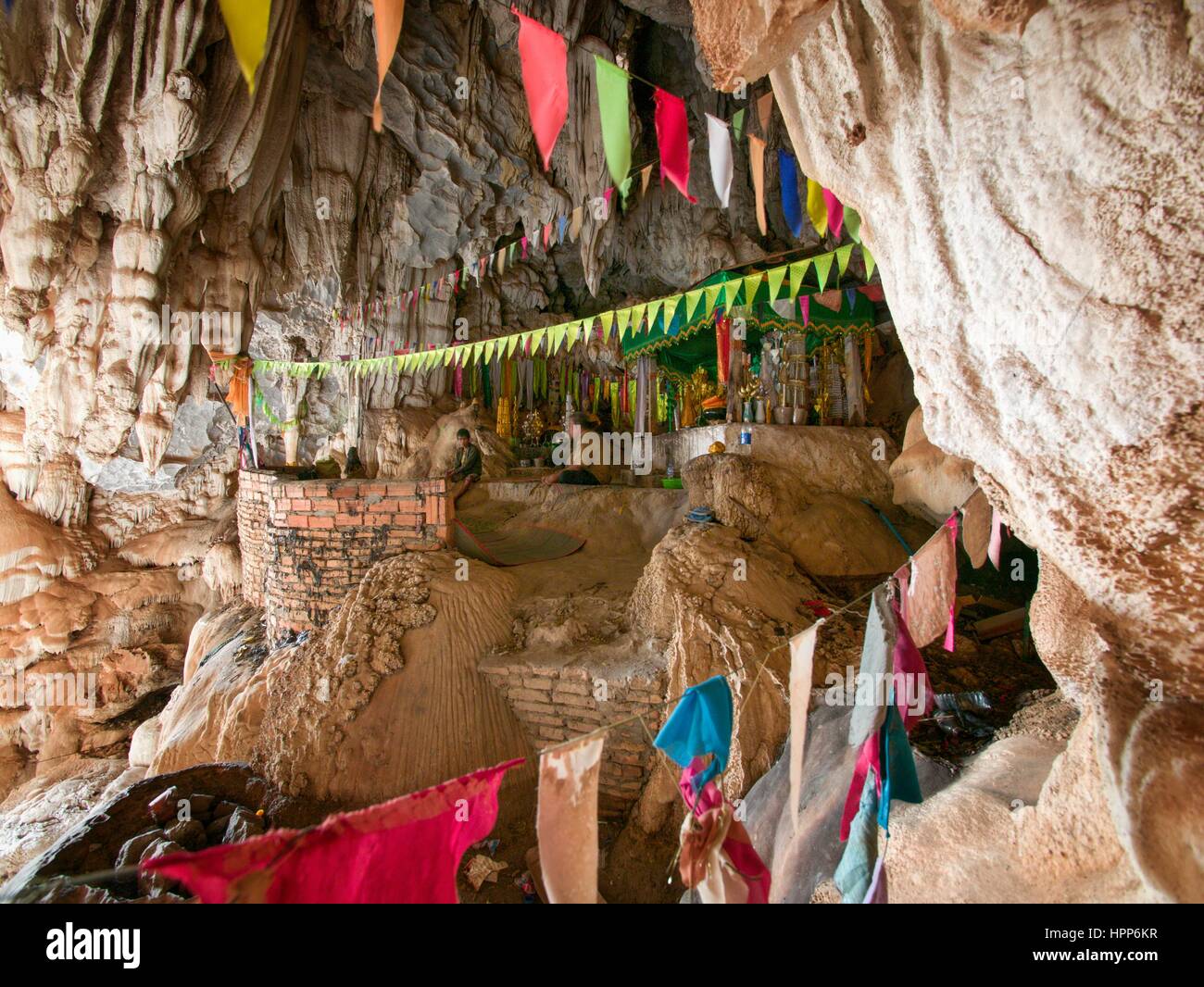 Altar and flags decorating the inside of a cave with unidentifiable ...