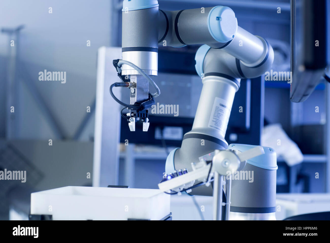 Robot arm in a sensor technology plant Stock Photo - Alamy