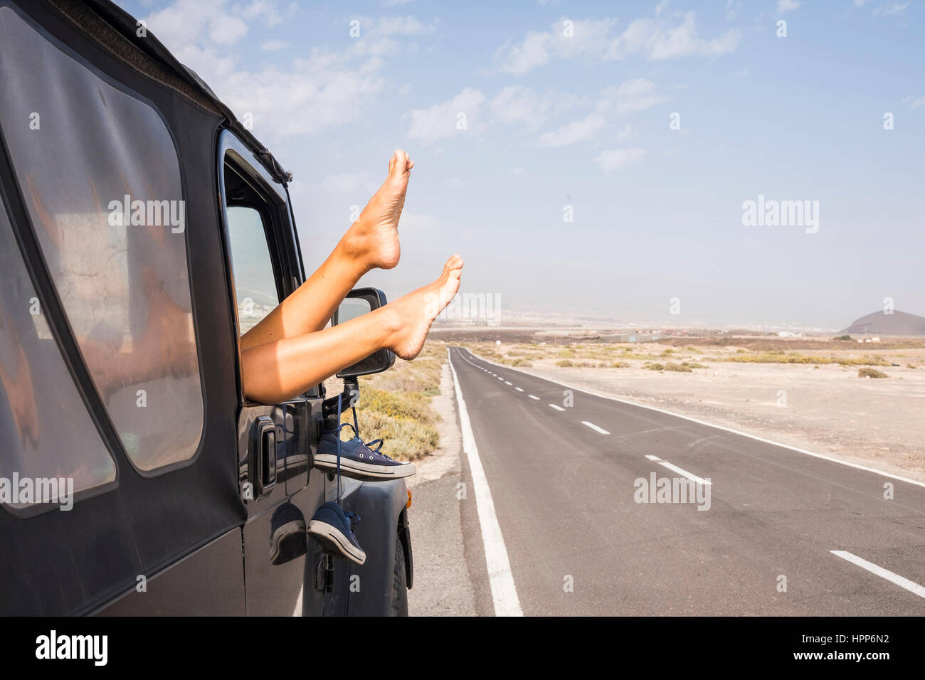 Legs hanging out window hi-res stock photography and images - Alamy