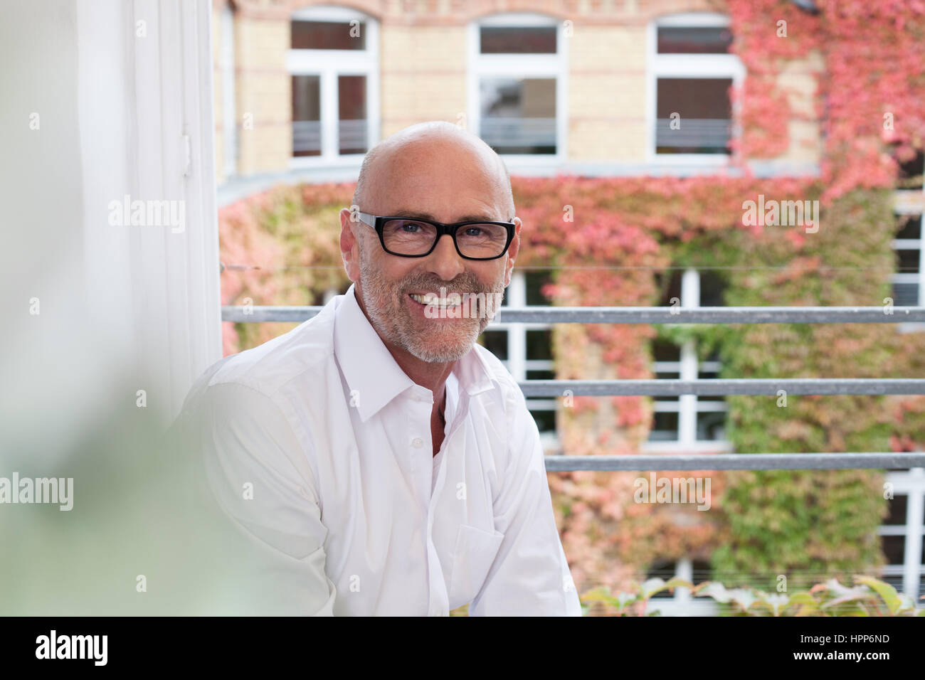 Portrait of smiling man at the window Stock Photo - Alamy
