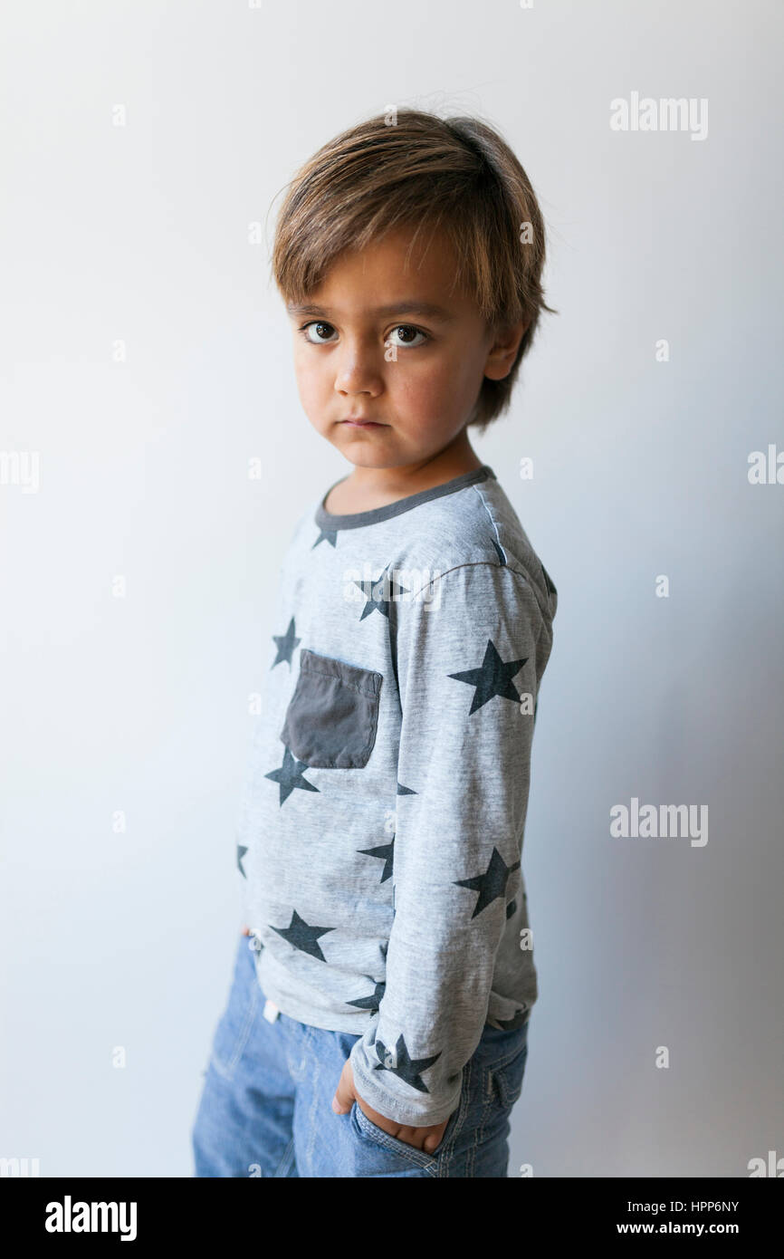 Portrait of serious little boy with hands in his pockets Stock Photo ...
