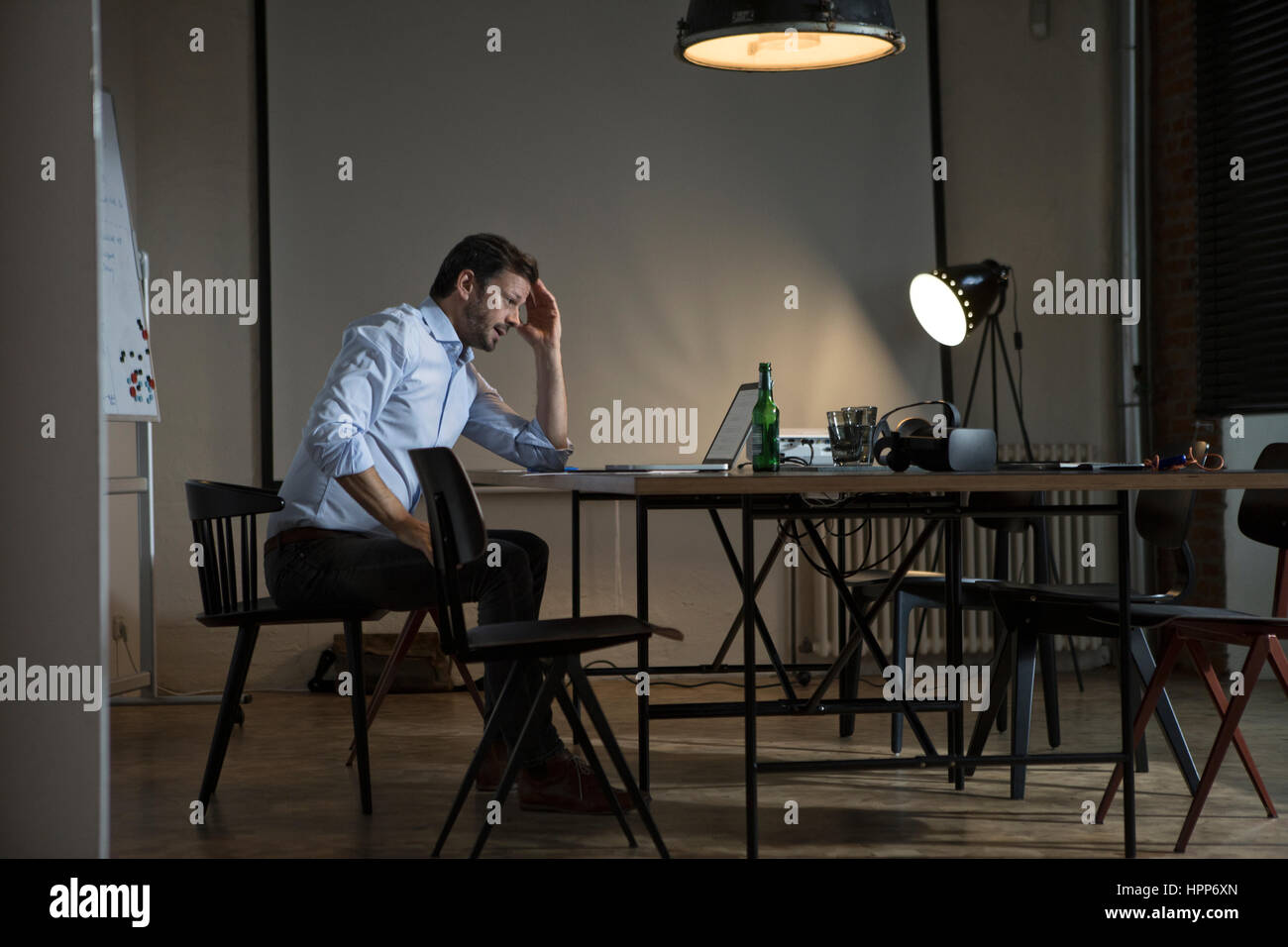Businessman working late in office Stock Photo - Alamy