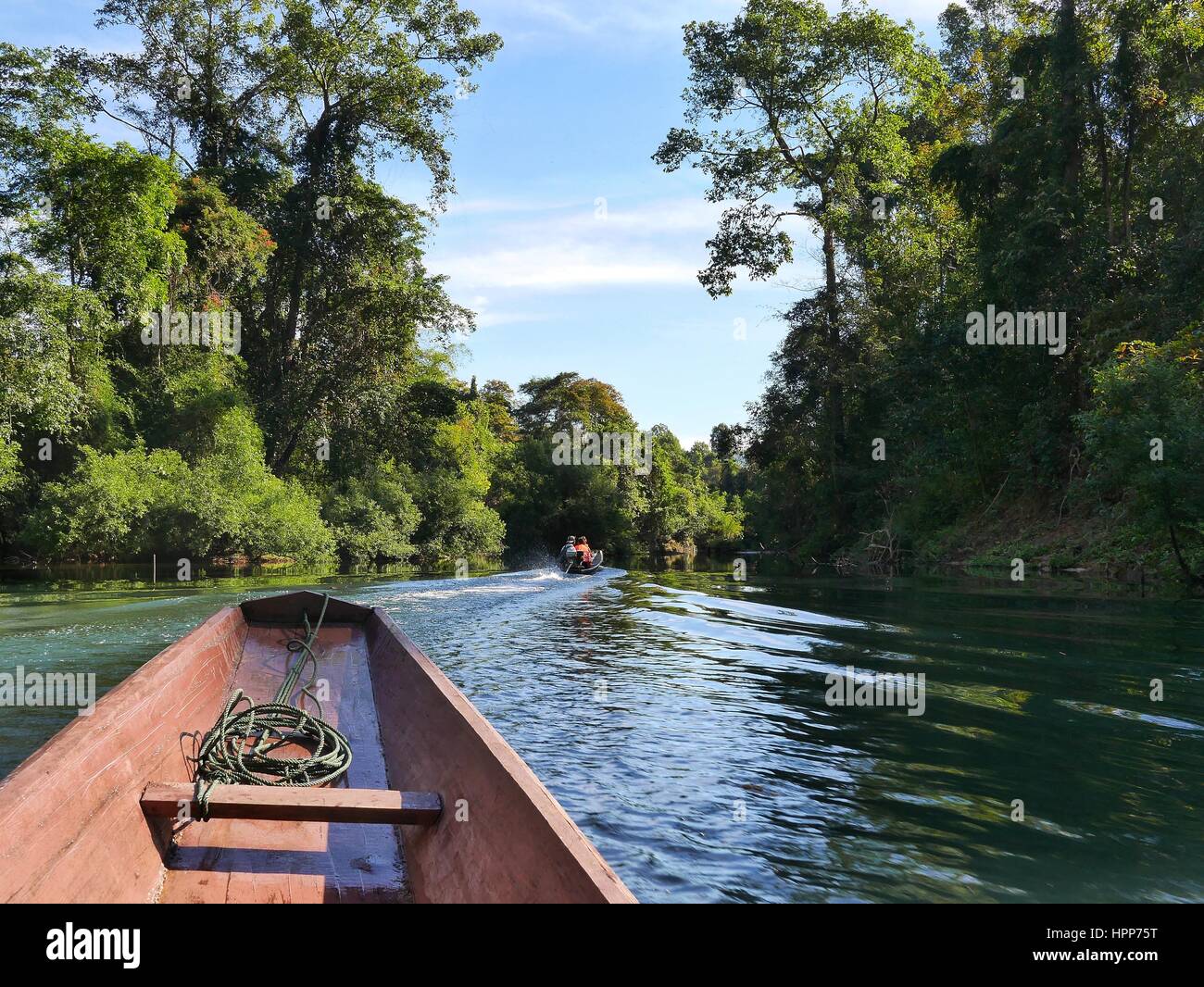 View from a boat on a river of the boats bow, the river and surrounding ...