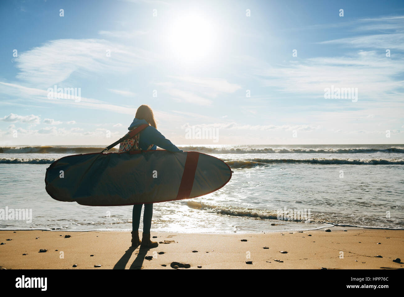 Back view of surfer carrying surfboard hi-res stock photography and ...
