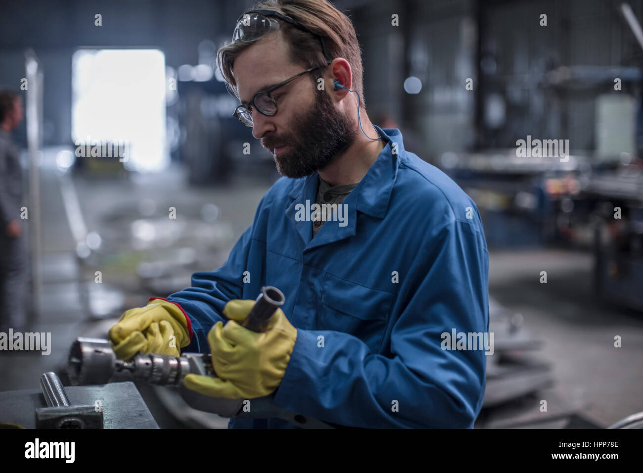 Factory worker operating power tool Stock Photo - Alamy