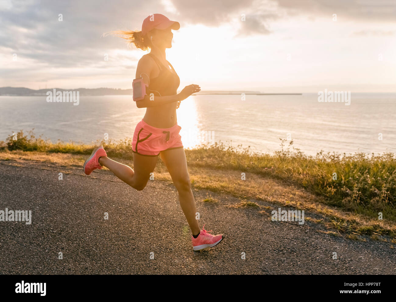 Young woman running at the sea Stock Photo - Alamy