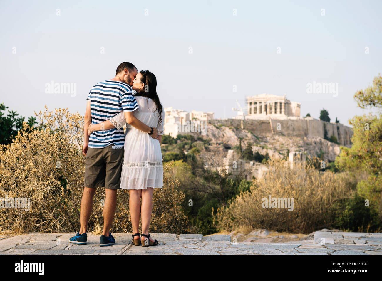 Greece, Athens, couple kissing at Areopagus with The Acropolis and ...