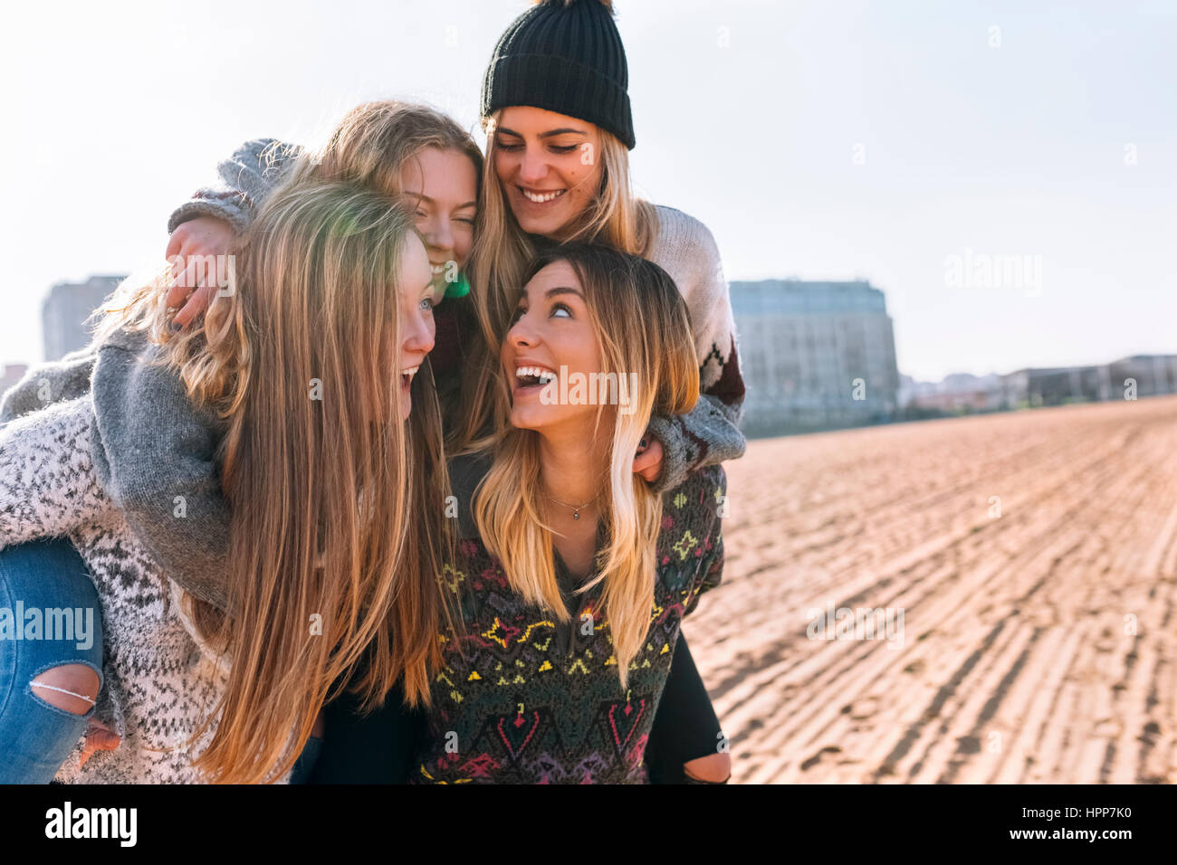 Four friends having fun on the beach Stock Photo - Alamy