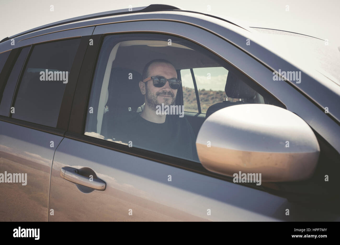 Portrait of smiling man in a car Stock Photo - Alamy