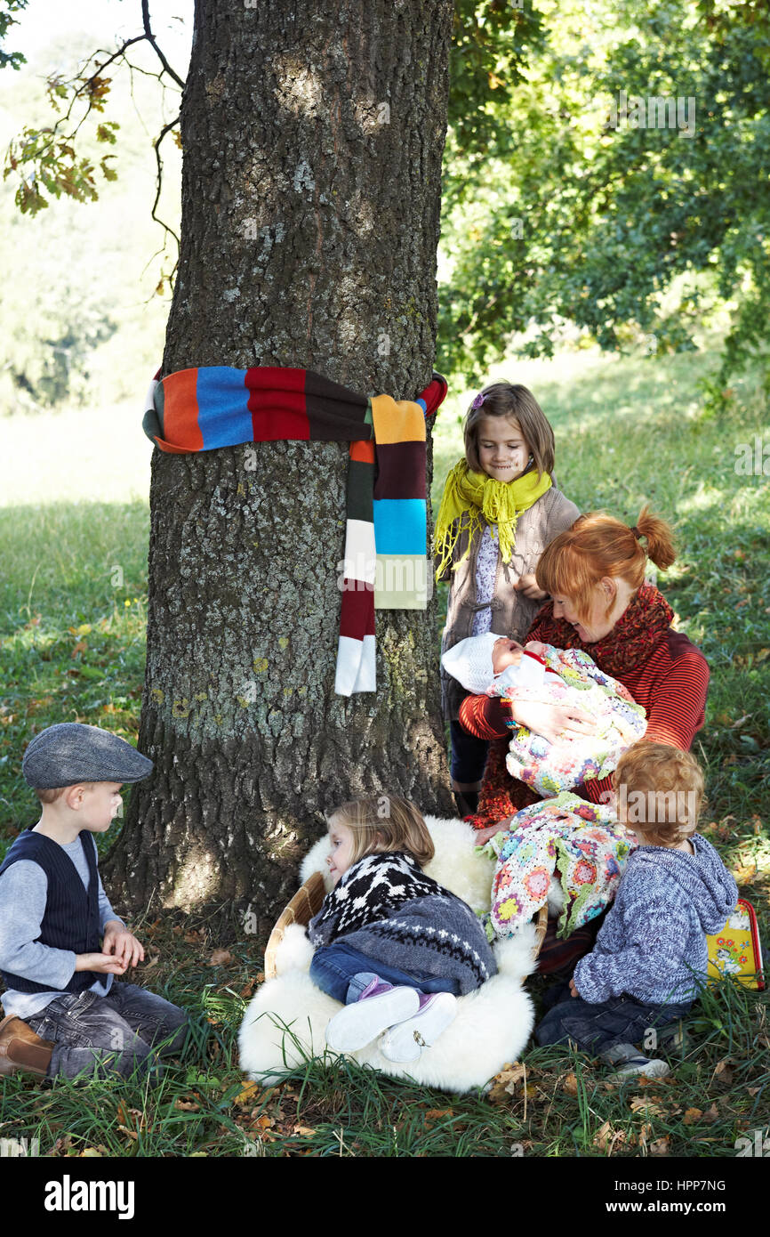 Mother with children in shadow at a tree Stock Photo - Alamy
