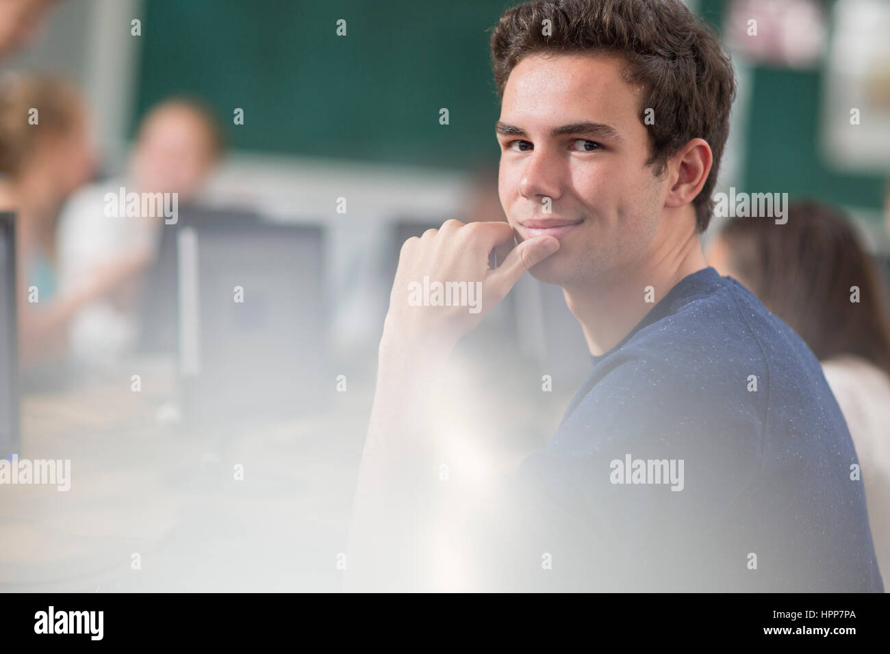 Portrait of smiling high school student in class Stock Photo - Alamy