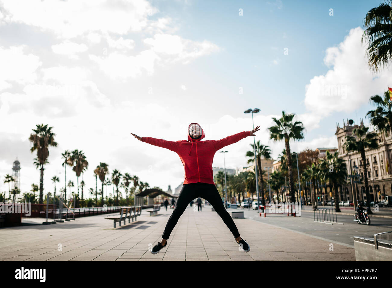 Young man in the city jumping on pavement Stock Photo - Alamy