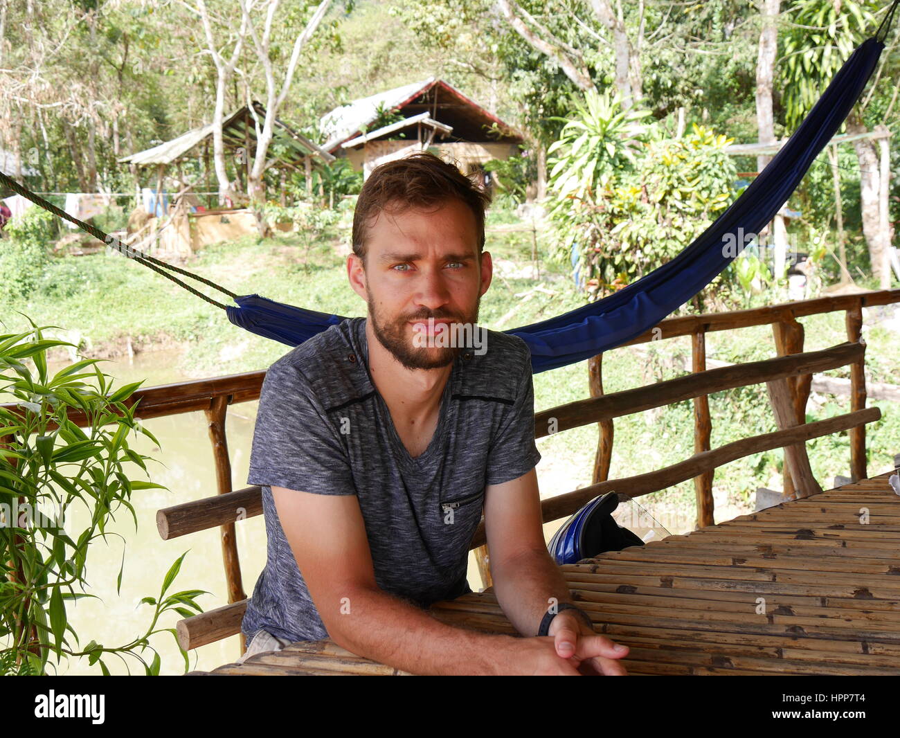 White caucasian man sitting at a table smiling Stock Photo - Alamy