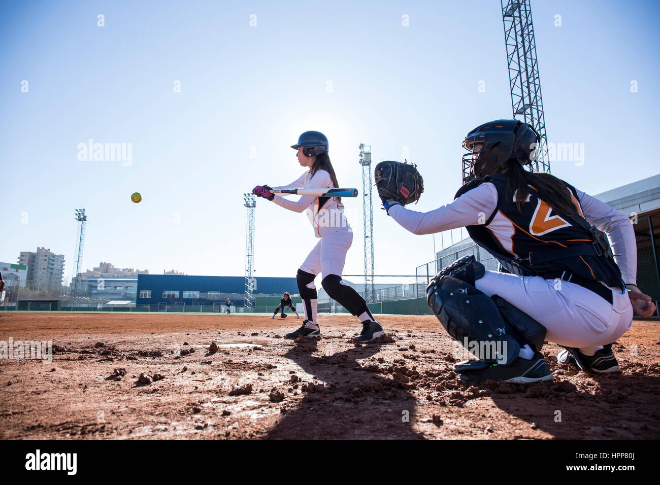 Female batter hitting the ball during a baseball game Stock Photo - Alamy