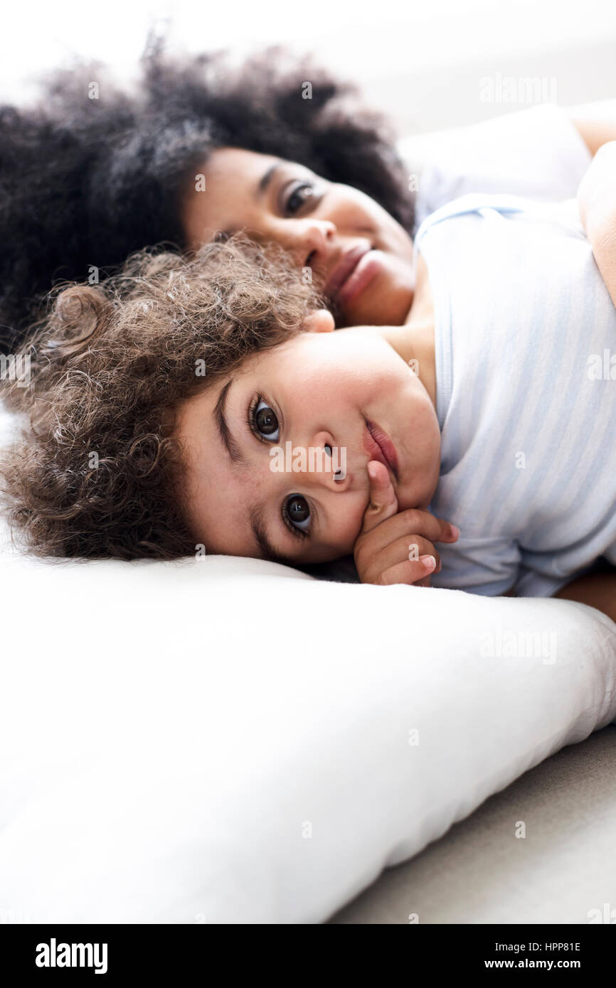 Portrait of little boy with his mother in the background Stock Photo ...