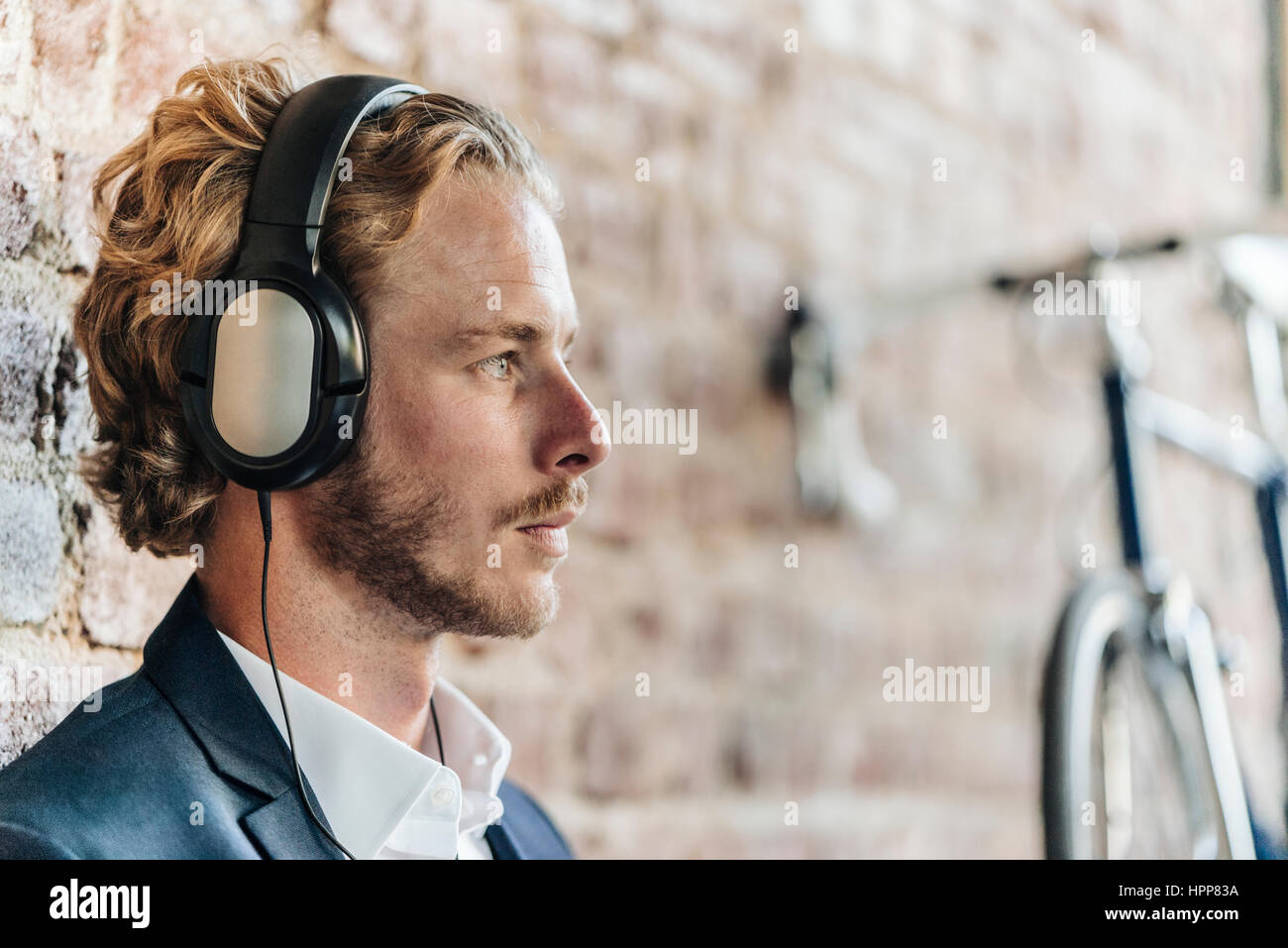 Businessman wearing headphones Stock Photo - Alamy