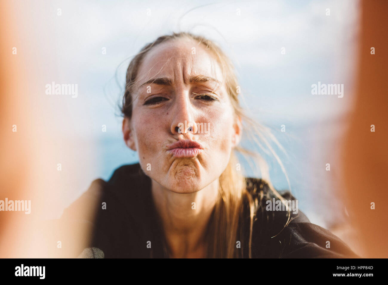 Selfie of young woman pouting Stock Photo - Alamy