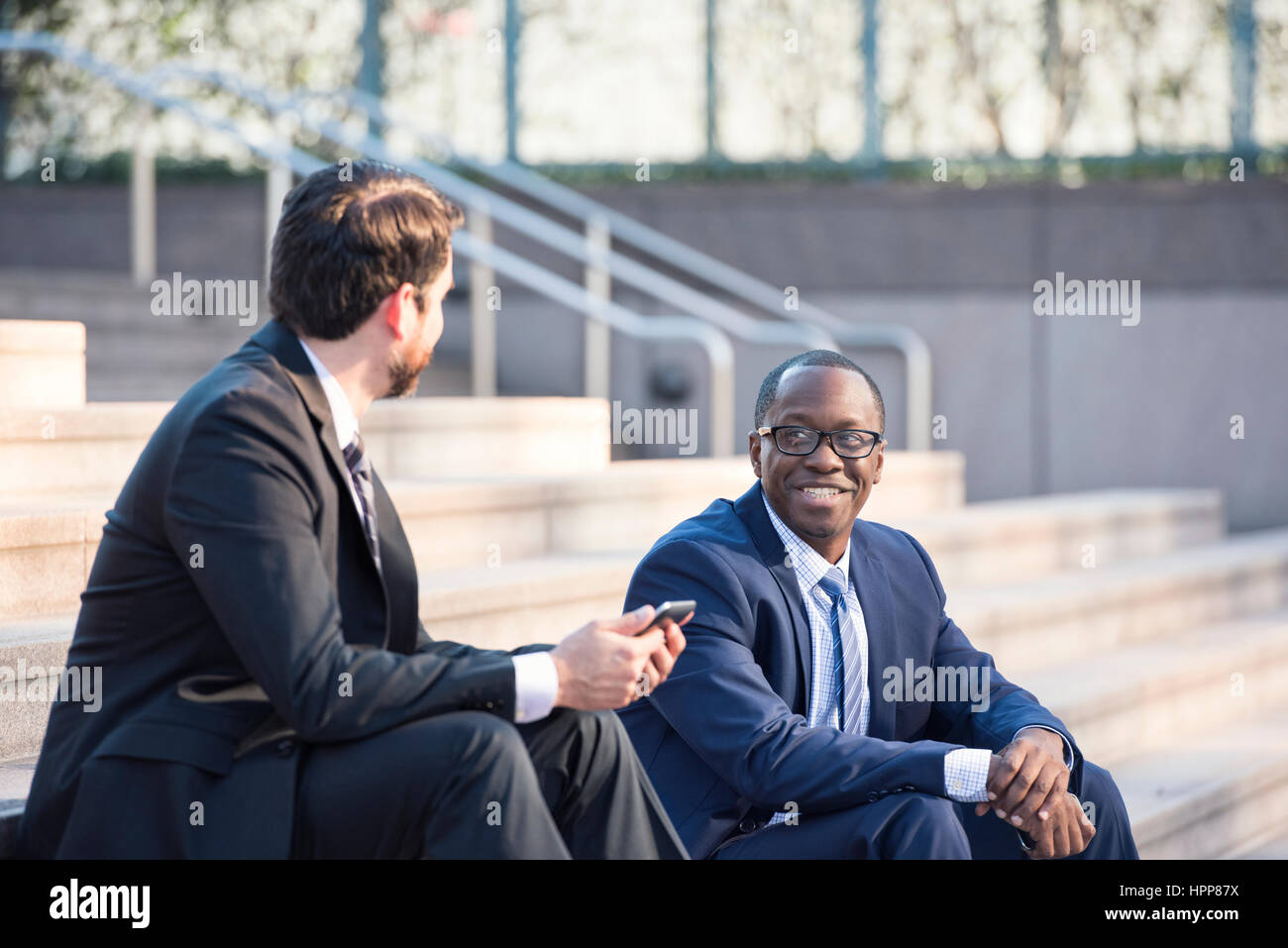 Two Men Sitting On Stairs Talking High Resolution Stock Photography and ...