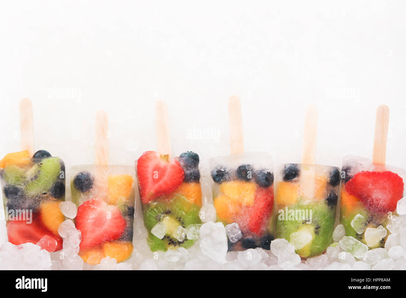 Row of six fruit ice lollies with fresh fruits on white ground Stock ...