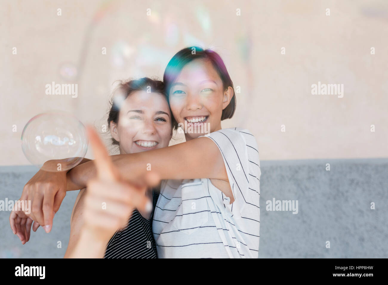 Two young women with soap bubble hi-res stock photography and images ...