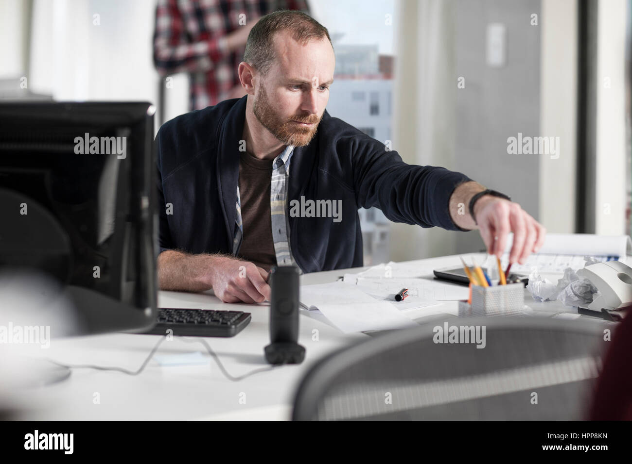 Man working at desk in office Stock Photo - Alamy