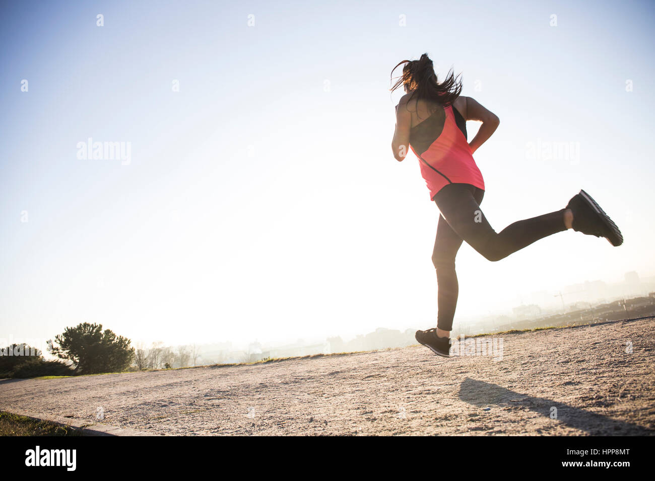Young woman running in sunlight Stock Photo - Alamy