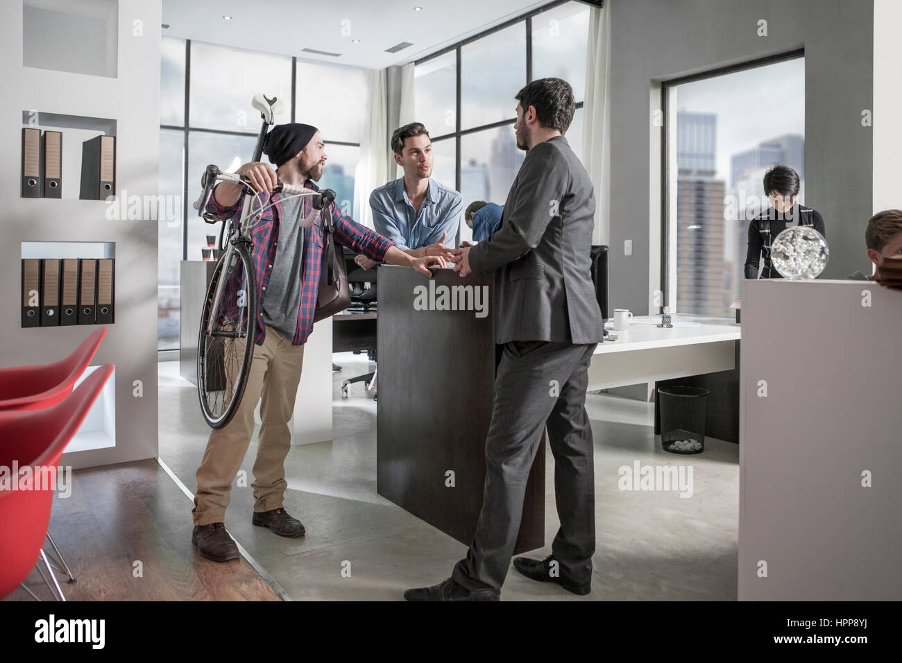 Businessman and staff talking in modern office Stock Photo - Alamy