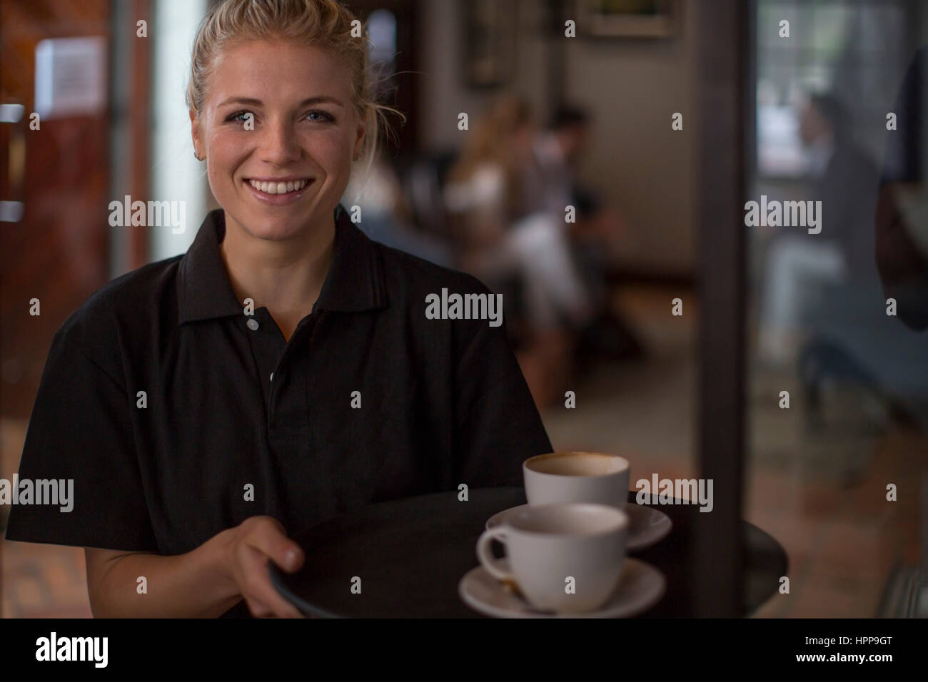 Portrait of smiling waitress in cafe Stock Photo - Alamy